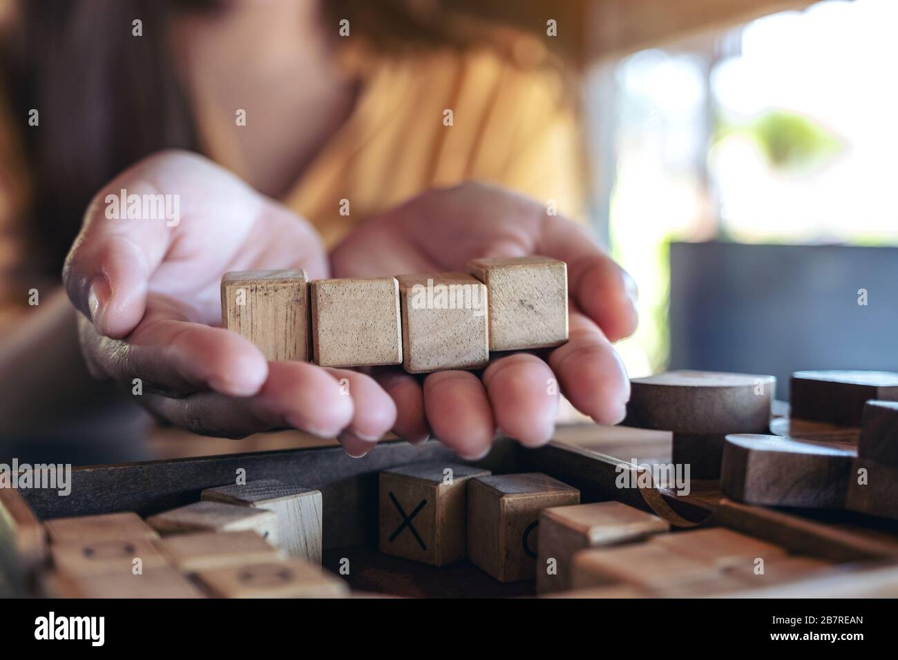 Woman stacking wooden block hi-res stock photography and images - Alamy