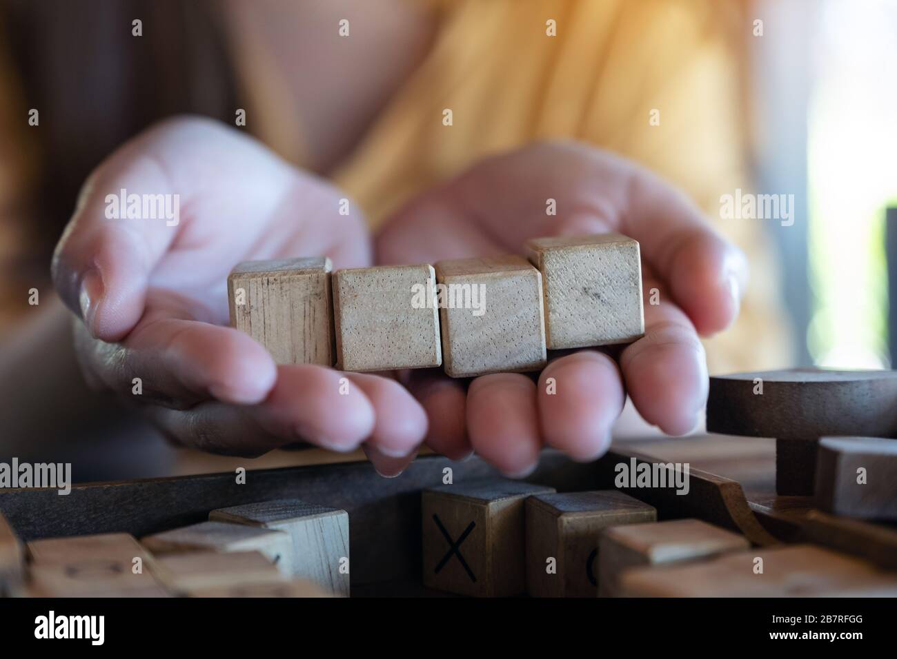Woman stacking wooden block hi-res stock photography and images - Alamy