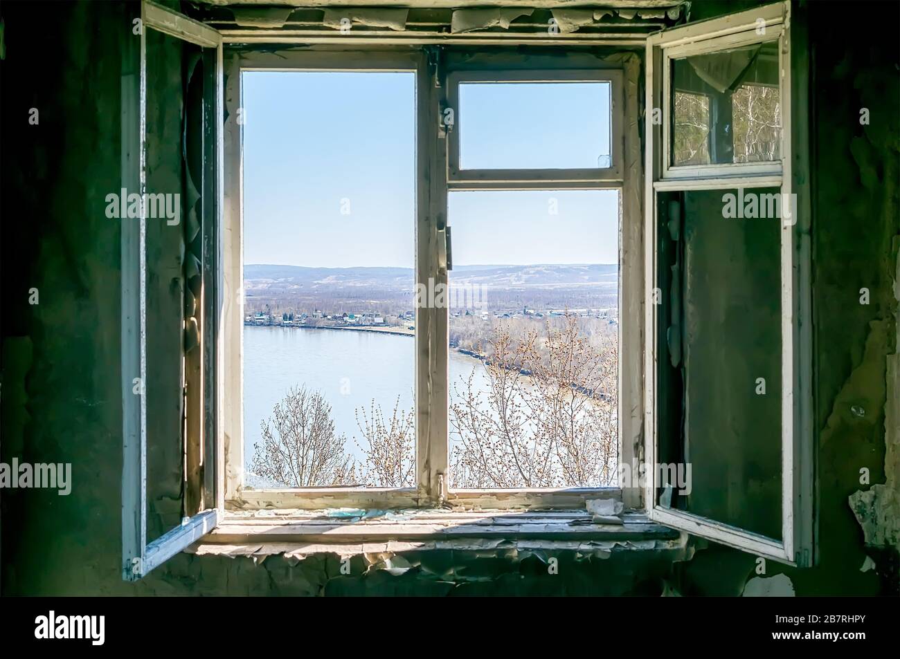 view of the river and the village from an old open window of an ...