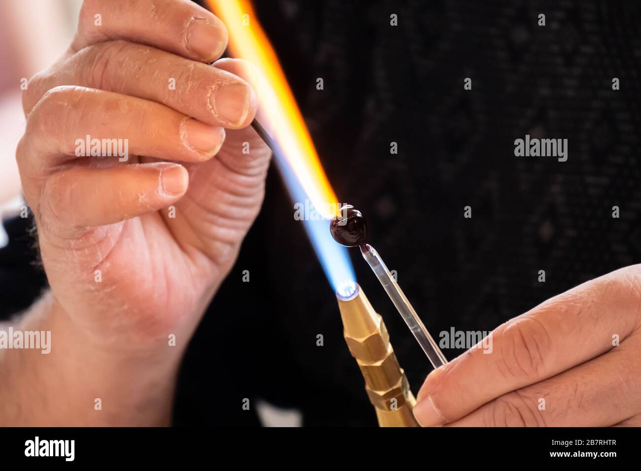 Hands of the handicrafts man making a glass subject of crafts. Glass ...
