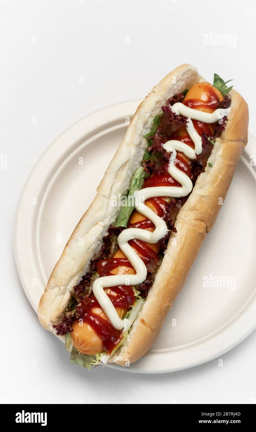 classic hot dog with frankfurter sausage and sauces on white studio ...