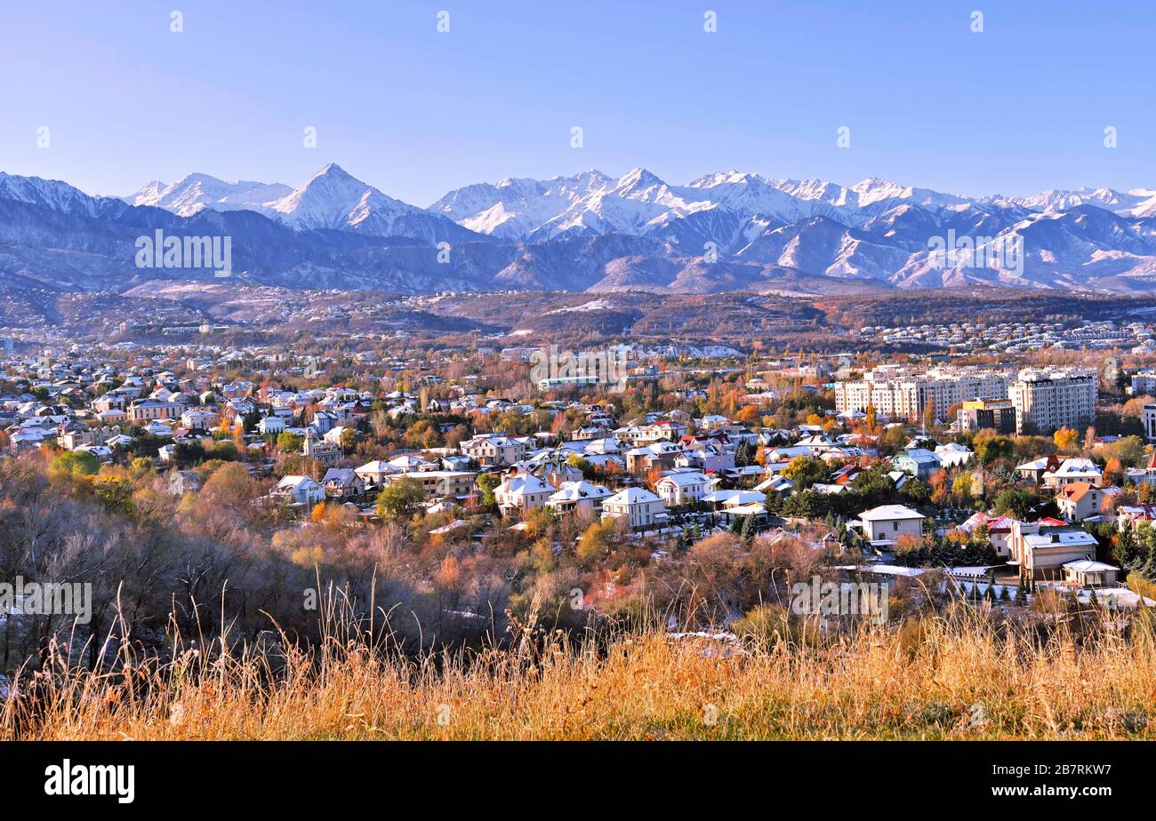 Upper part of Almaty city on the background of mountains in autumn ...