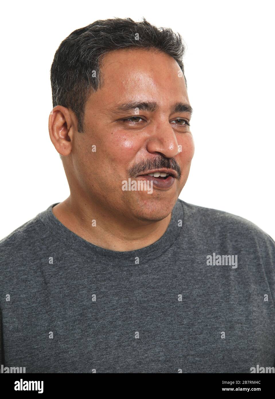 A smiling Indian man in a studio against a white background Stock Photo ...