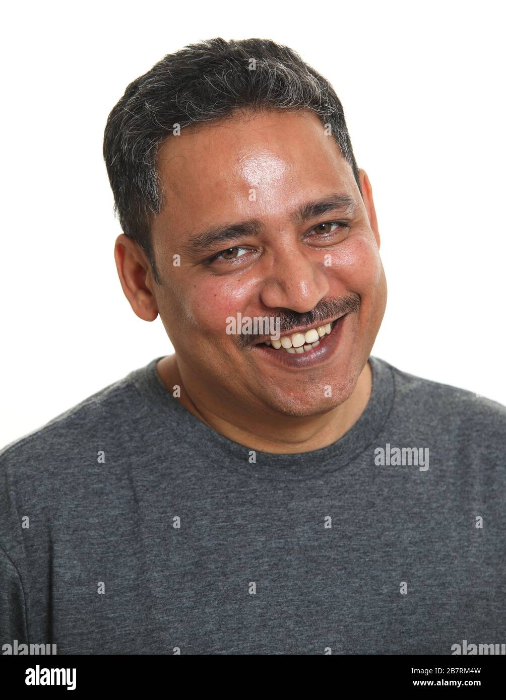A smiling Indian man in a studio against a white background Stock Photo ...