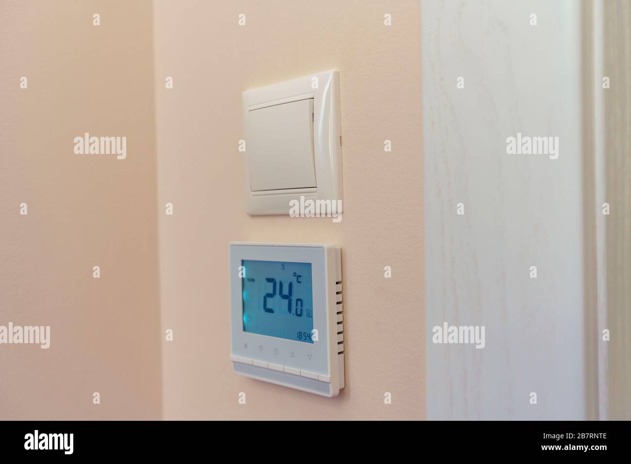on the wall of the room there is a light switch and under it a floor ...