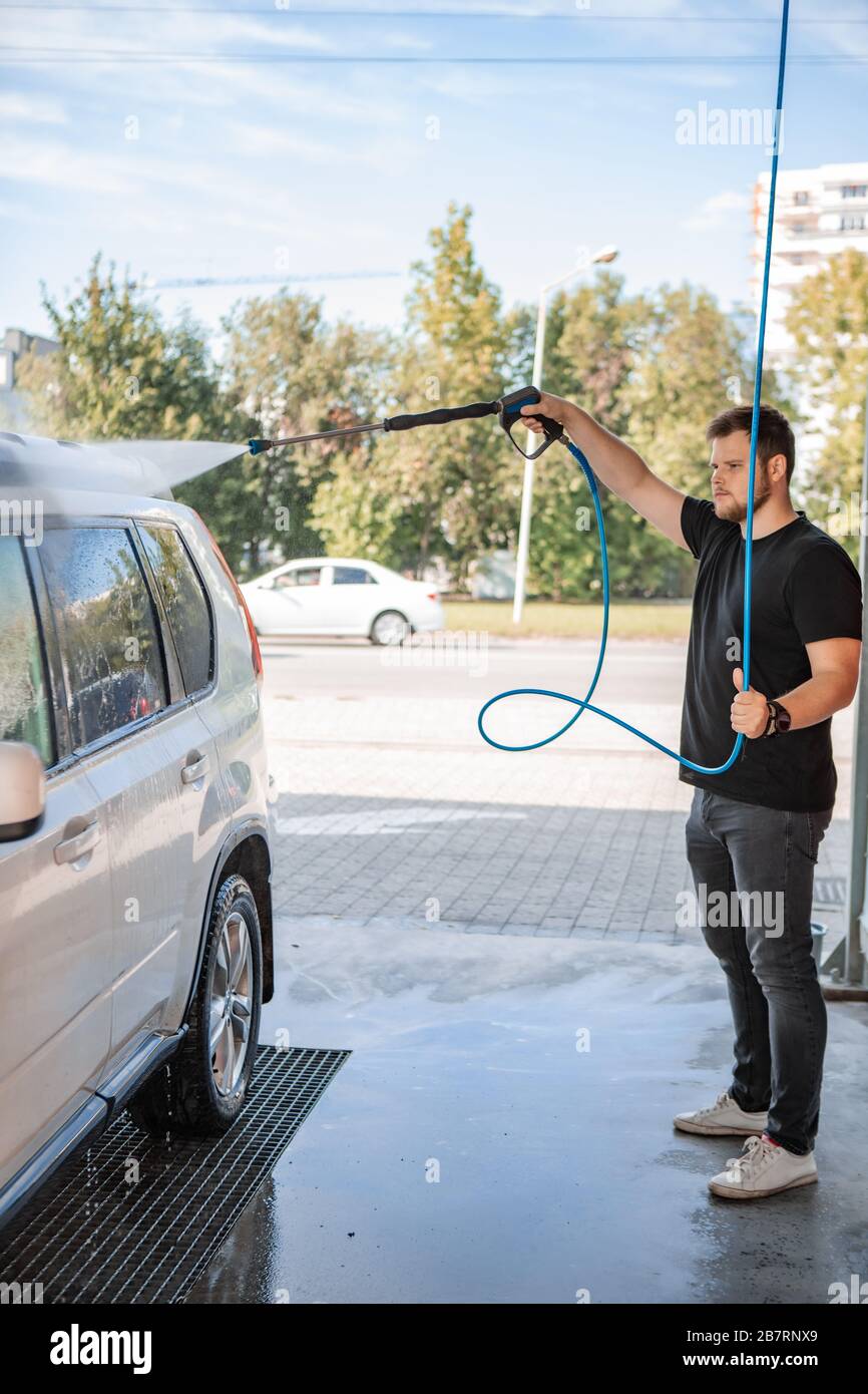 strong man washing car at self carwash outdoors Stock Photo - Alamy