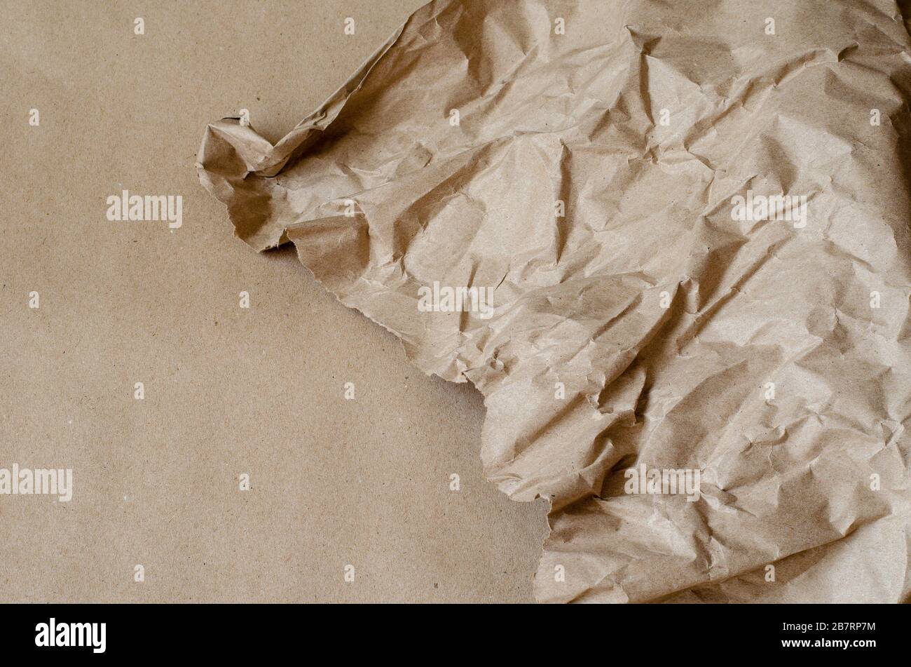Brown paper background. Crumpled piece of paper with a torn edge. Eye ...