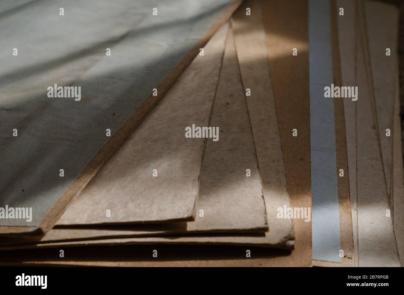 Sheets of old cardboard in the sun. Sheets of dusty construction ...