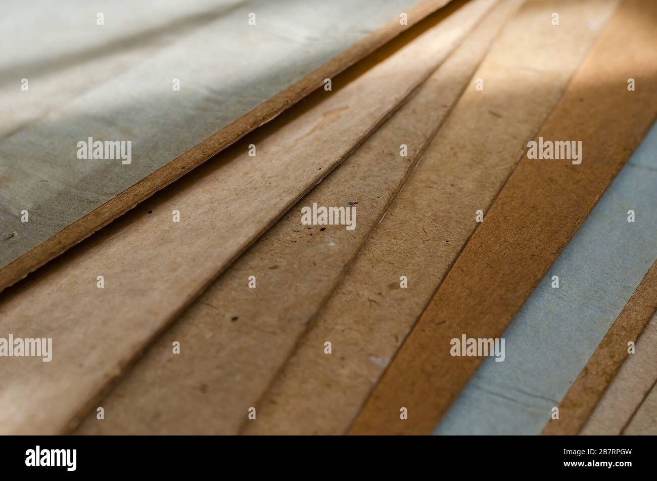 Sheets of old cardboard in the sun. Sheets of dusty construction ...