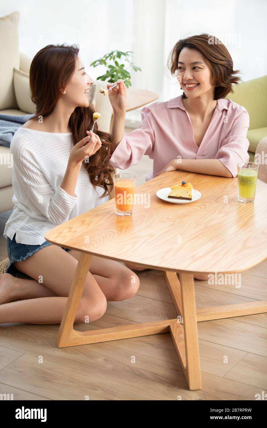 Young Chinese friends having afternoon tea at home Stock Photo - Alamy