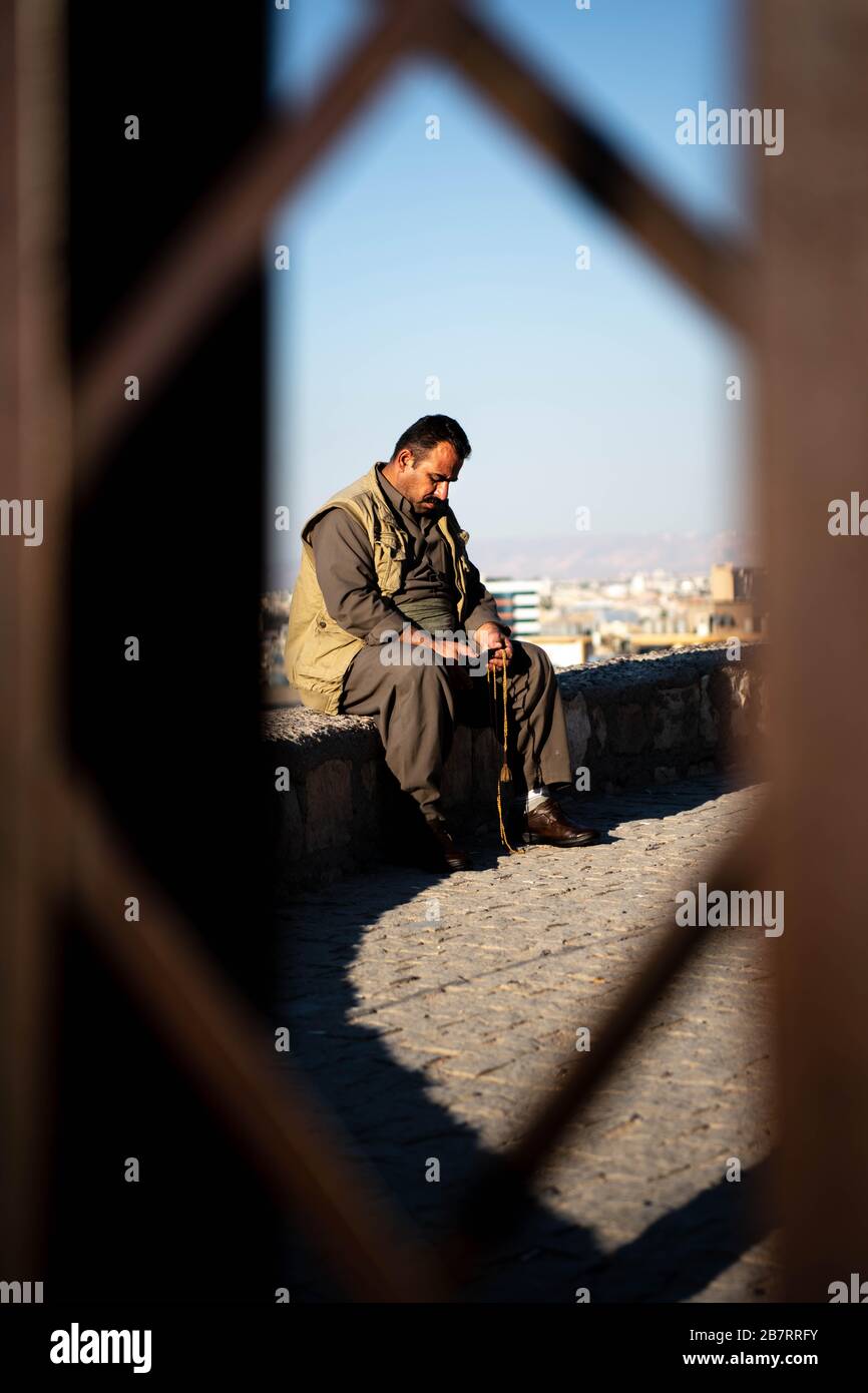 Framed view of a Kurdish man in traditional clothing taking a selfie ...