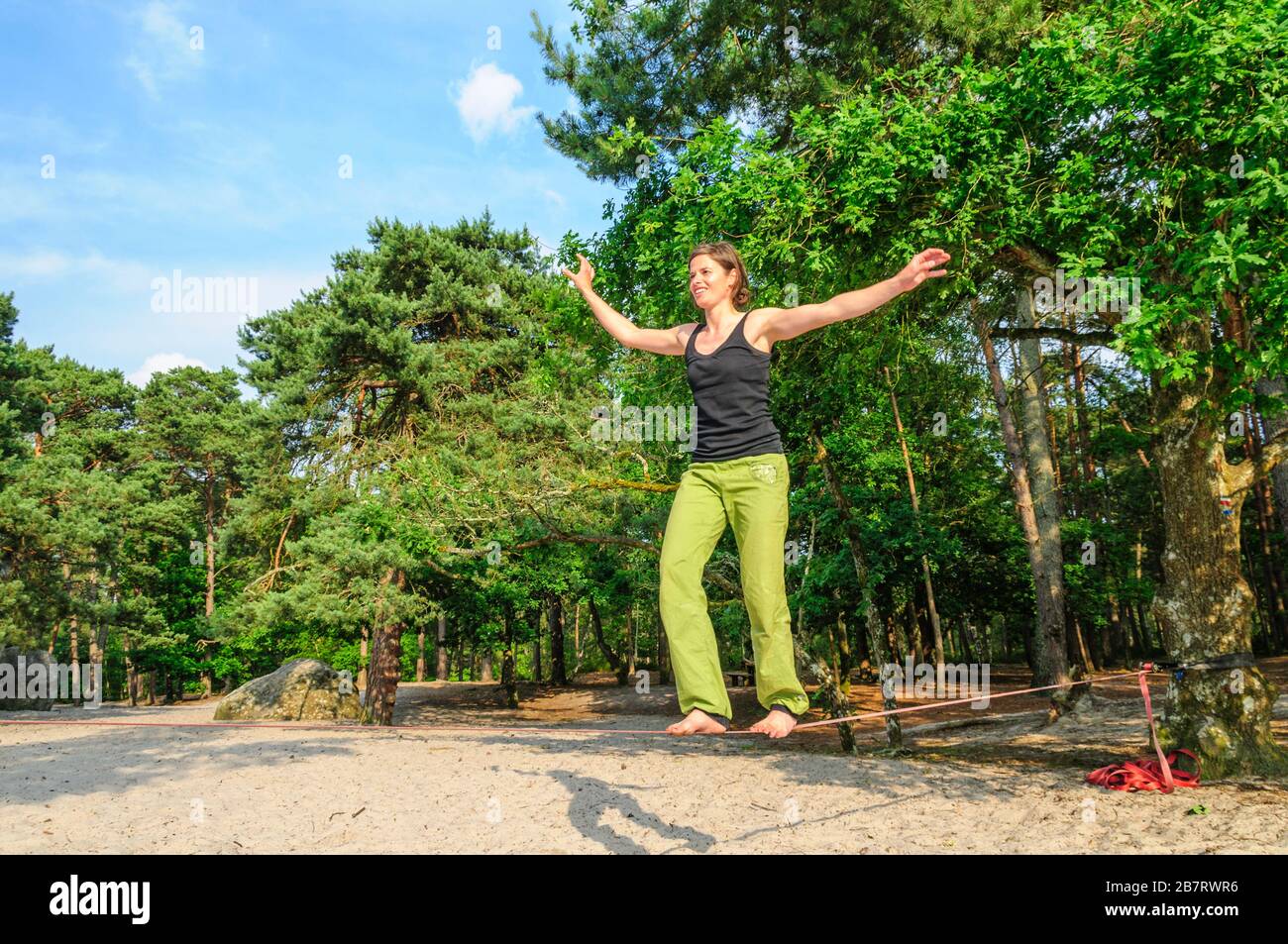 Woman balancing on Slackline in the forests of Fontainebleau Stock ...