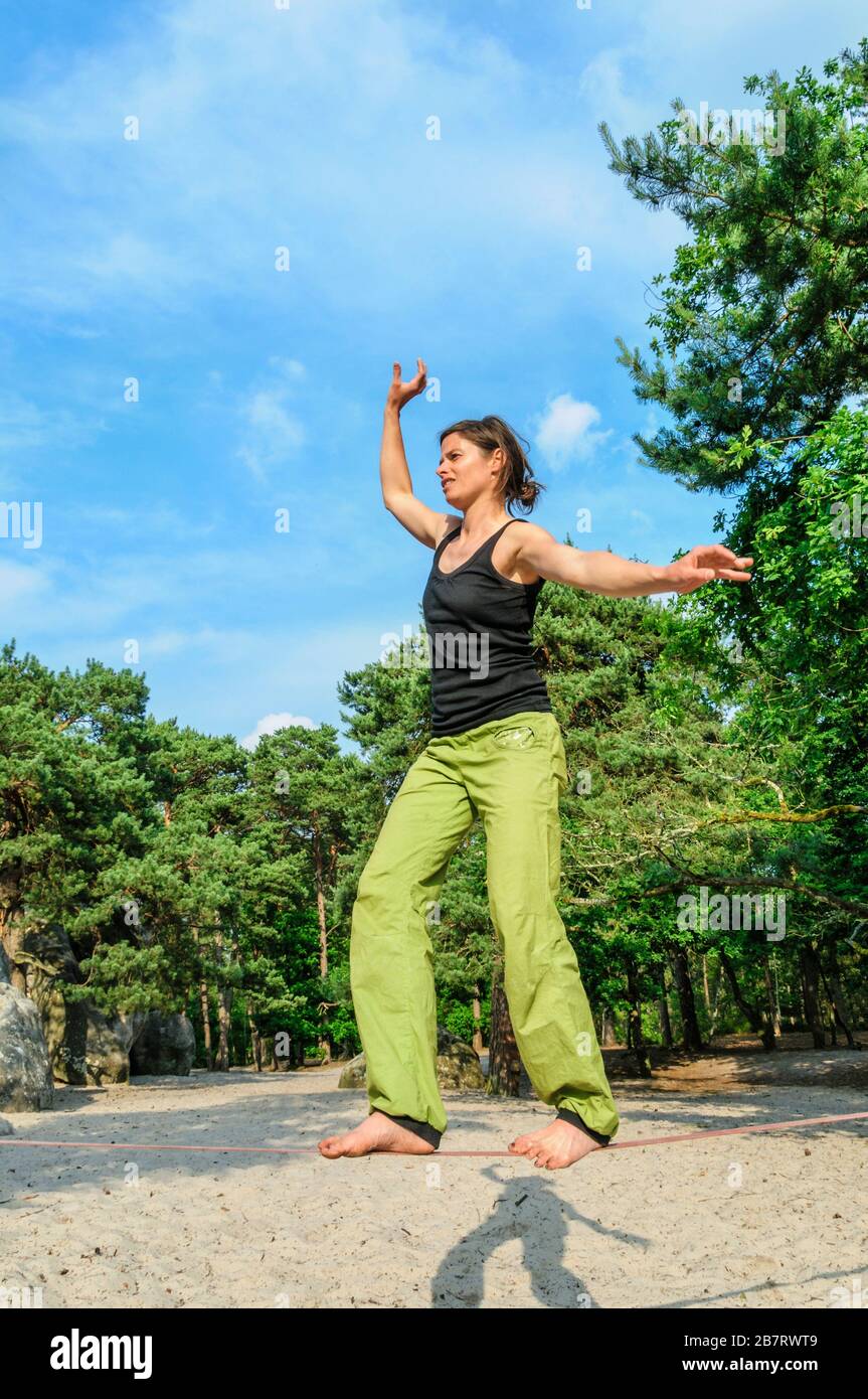 Woman balancing on Slackline in the forests of Fontainebleau Stock ...