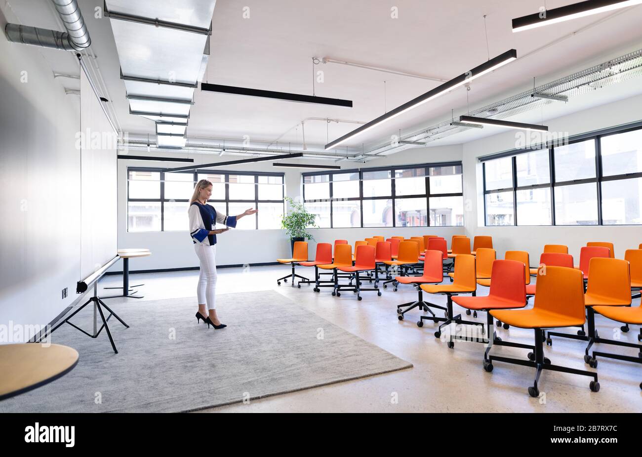 Caucasian woman standing in a conference room Stock Photo - Alamy