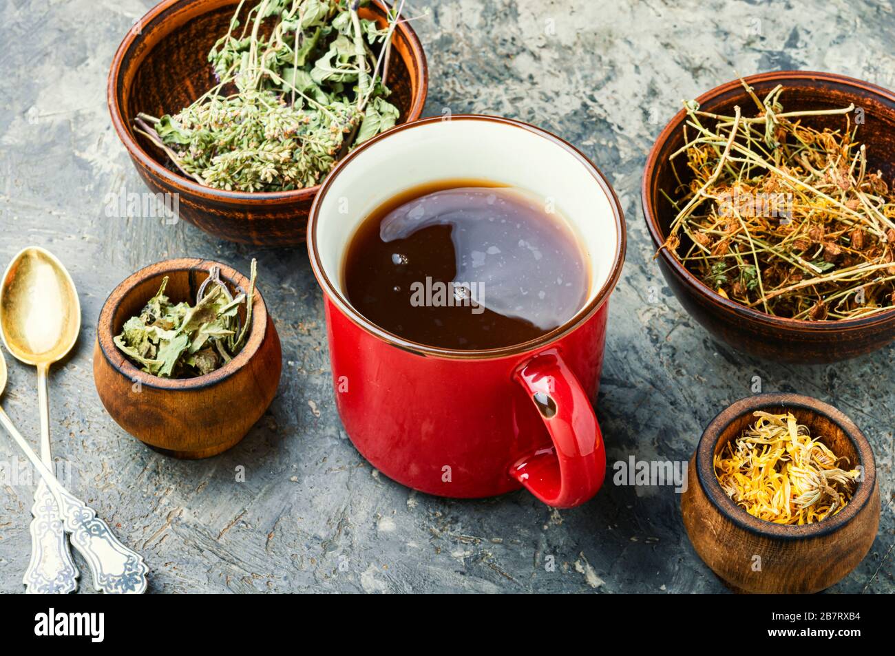 Healing herbs and herbal tea.Glass cup of green tea.Various herbal tea ...
