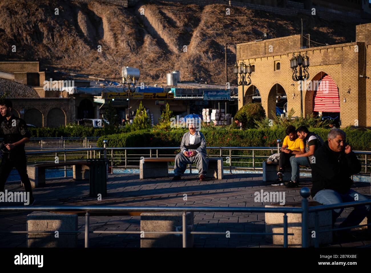Iraq, Iraqi Kurdistan, Arbil, Erbil. On the park Shar men are sitting ...