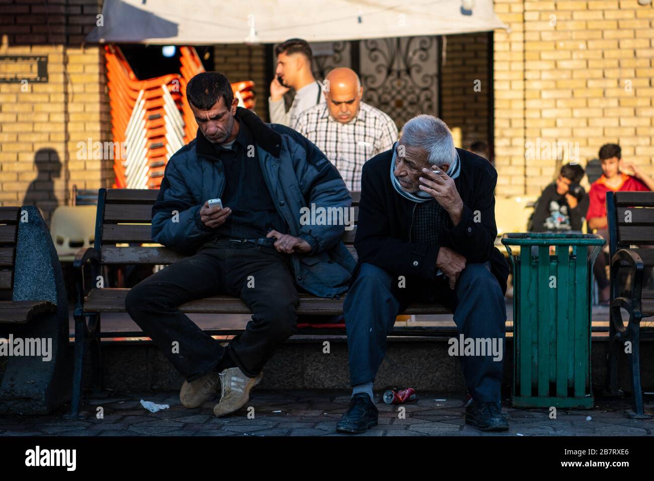 Iraq, Iraqi Kurdistan, Arbil, Erbil. On the park shar, two men are ...