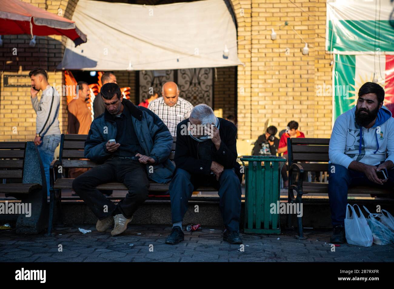 Iraq, Iraqi Kurdistan, Arbil, Erbil. On the park shar, three men are ...