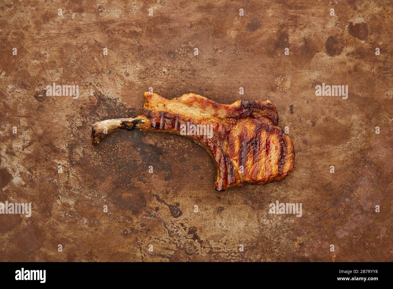 Top view of grilled ribeye steak on textured stone surface Stock Photo ...