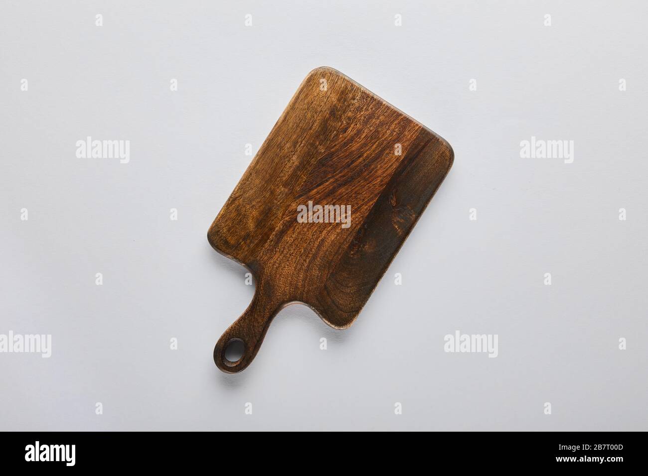 Top view of wooden cutting board on white background Stock Photo - Alamy