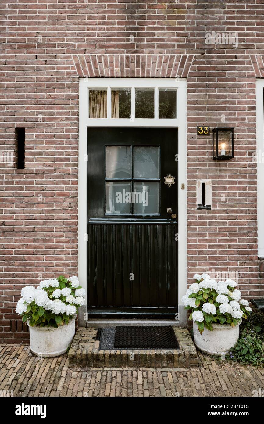 Naarden, The Netherlands - July 7, 2019: Traditional black door on a ...
