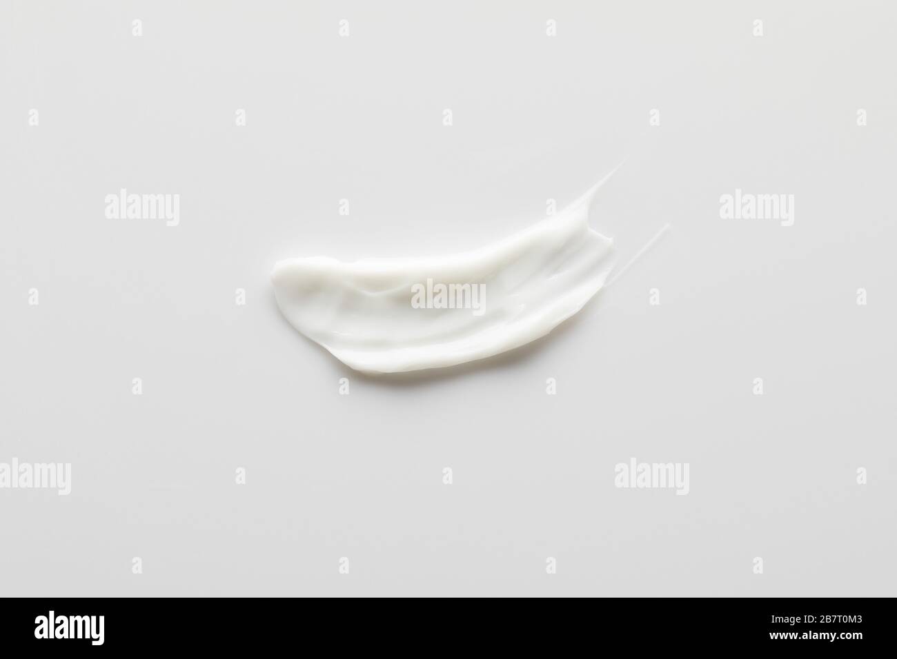 Top view of cosmetic cream brushstroke on grey background Stock Photo ...