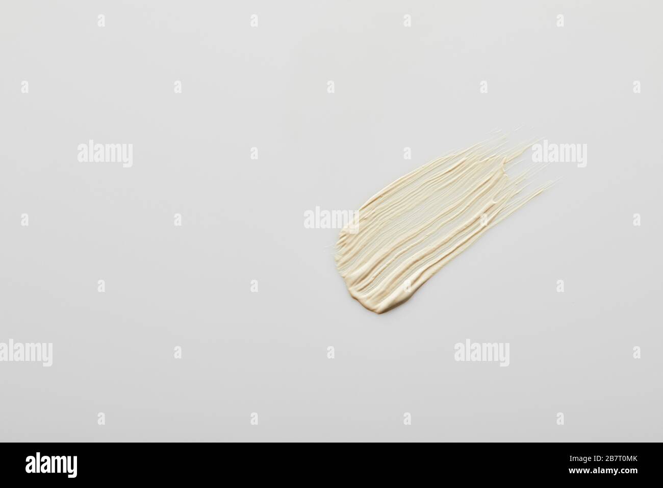 Top view of tone cream brush strokes on grey background Stock Photo - Alamy