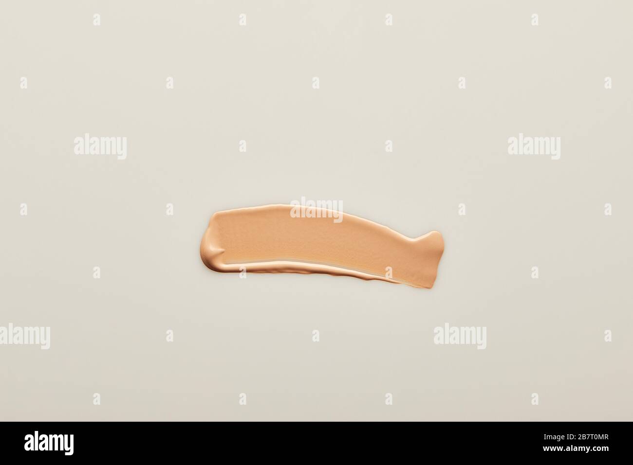 Top view of tone cream brushstroke on grey background Stock Photo - Alamy