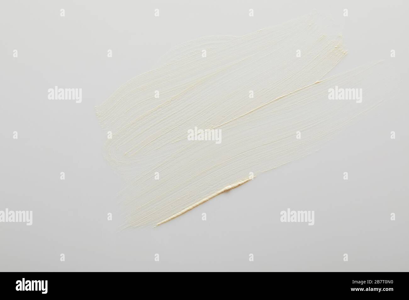 Top view of tone cream brush strokes on grey background Stock Photo - Alamy