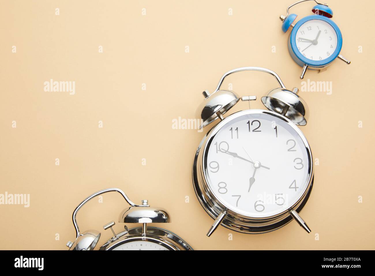 top view of classic alarm clocks on beige background Stock Photo - Alamy