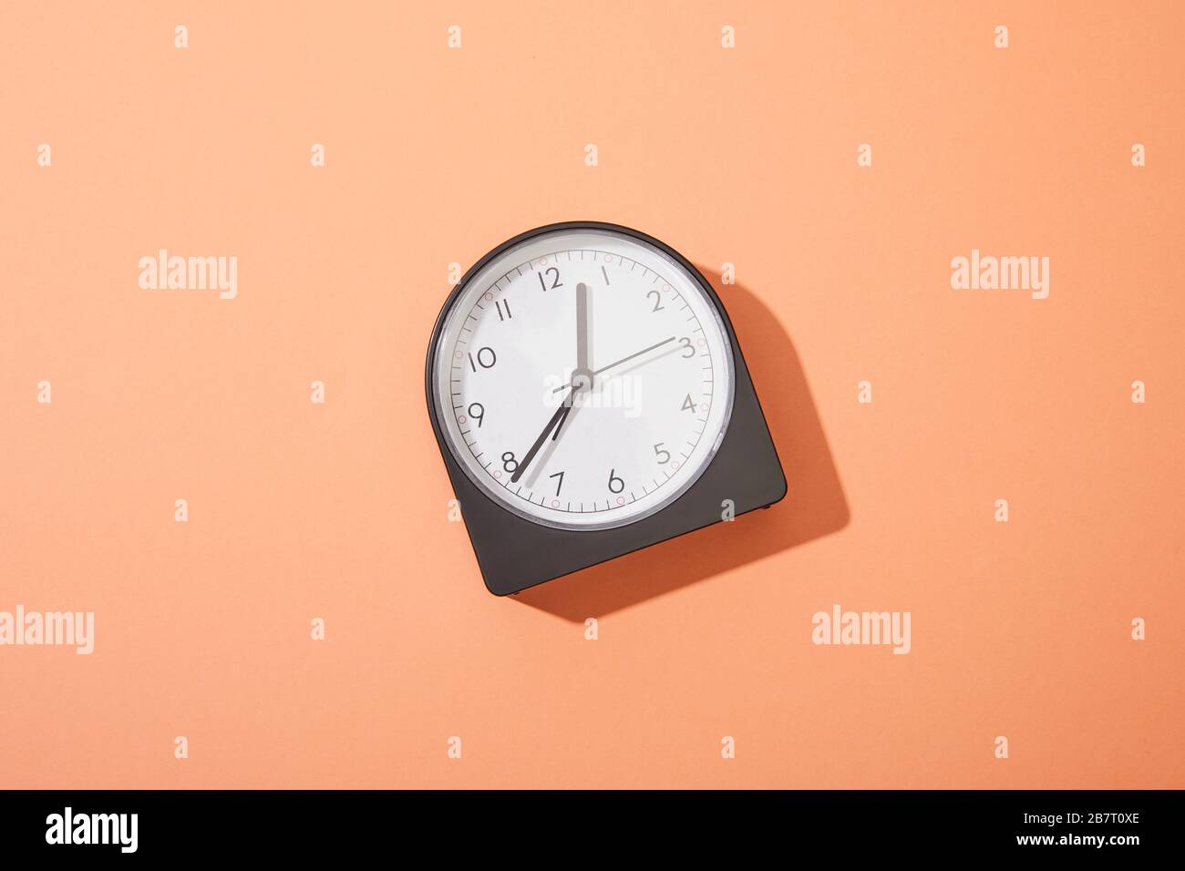 top view of clock on peach background Stock Photo - Alamy