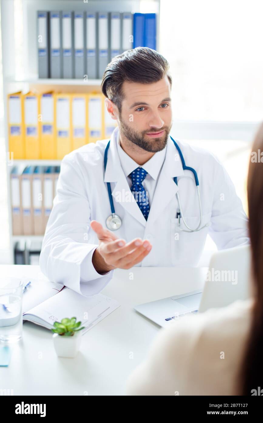 Vertical photo of a professional doctor having a consultation with his ...