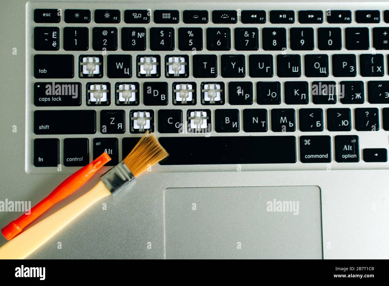 screwdriver and spare parts from a laptop. Keyboard, brush, keys ...