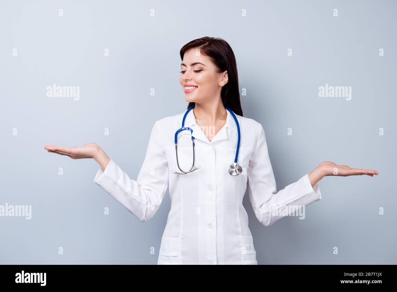 Happy smiling doctor asking to make a choice between two objects Stock ...