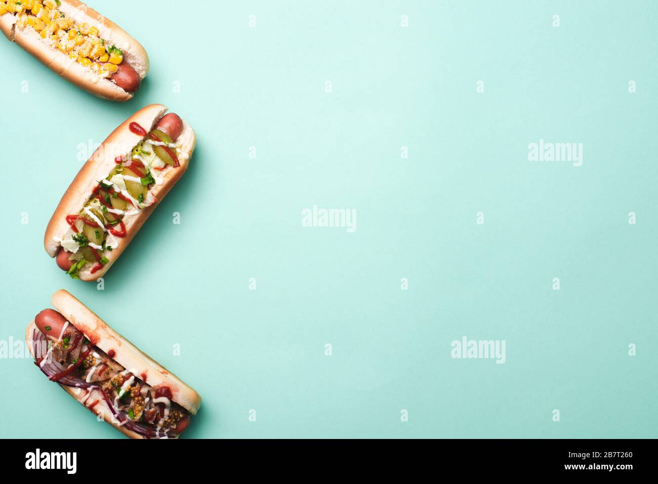 top view of three unhealthy hot dogs on blue Stock Photo - Alamy