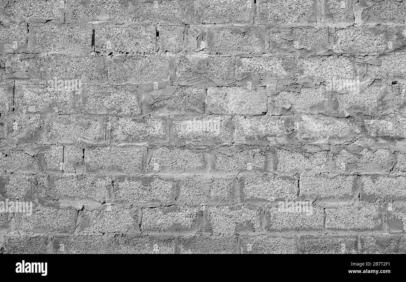 Grey brick wall as a background Stock Photo - Alamy