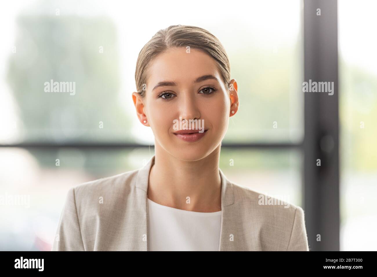front view of attractive businesswoman looking at camera with gently ...