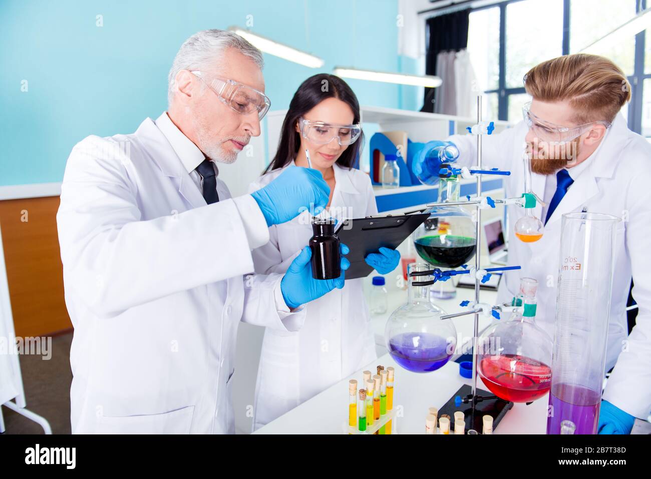 Team work. Three scientists are working together for new experiment in ...