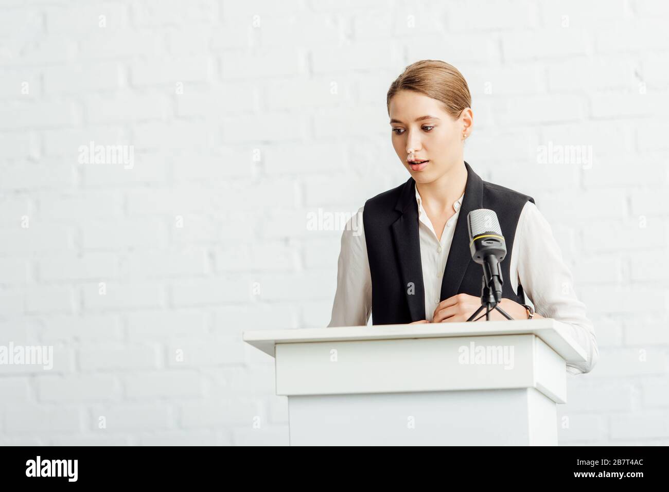 Businesswoman speaking at podium hi-res stock photography and images ...