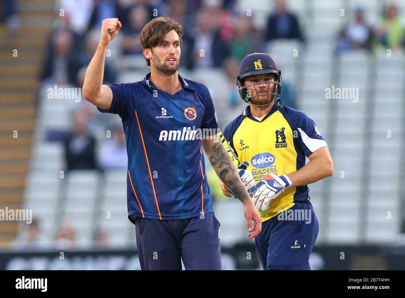 Reece Topley of Essex celebrates taking the wicket of Laurie Evans (R ...