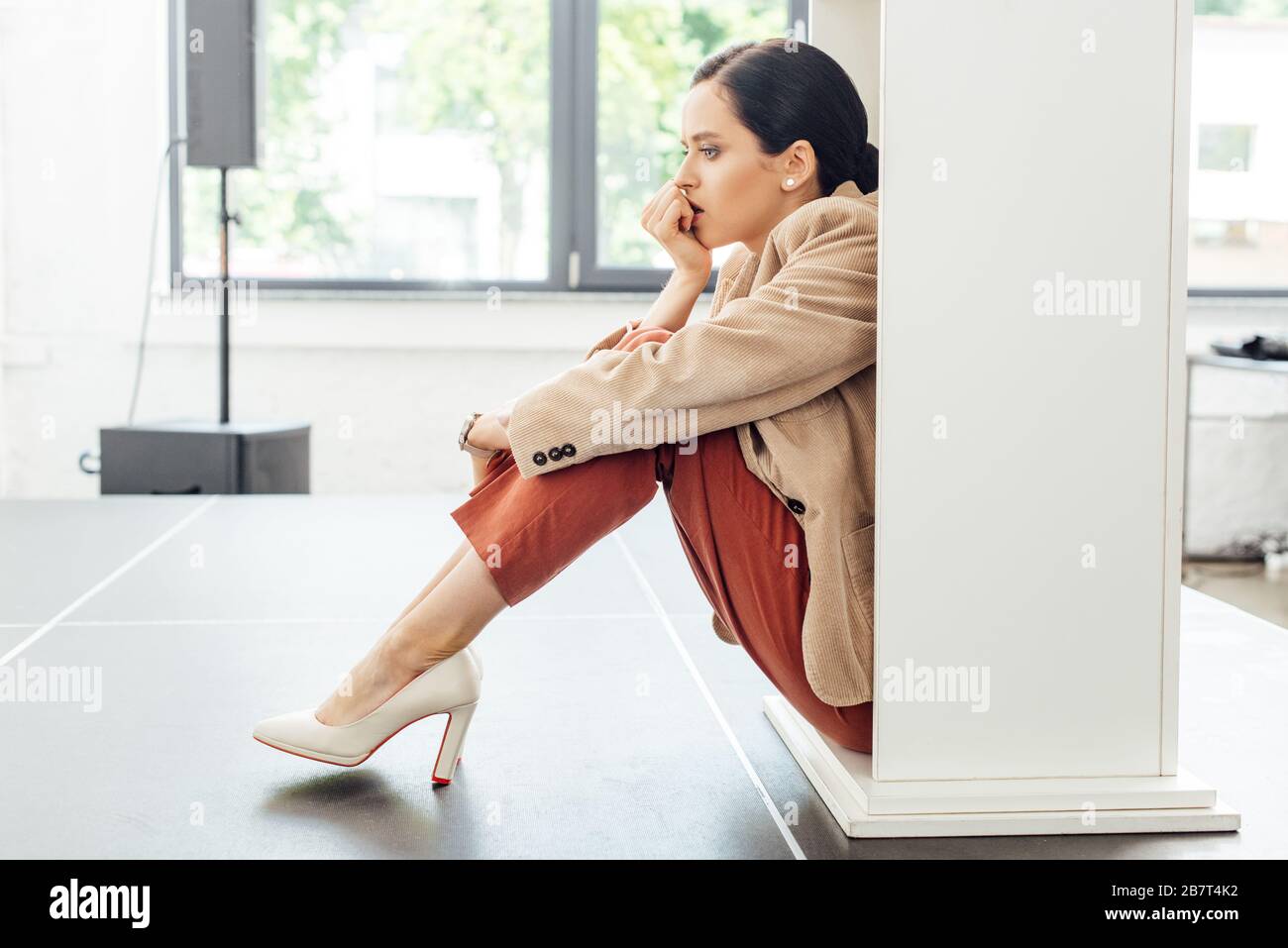 Woman sitting on floor scared hi-res stock photography and images - Alamy