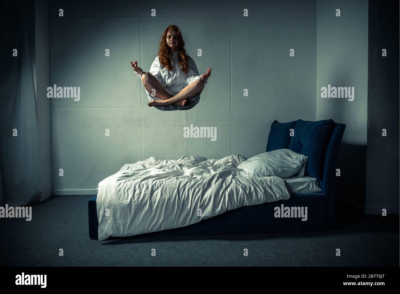 obsessed girl levitating in lotus pose during meditation over bed Stock ...