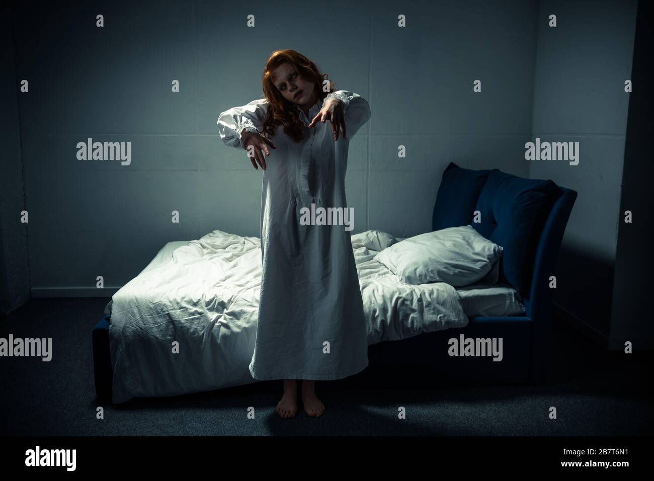 creepy female demon in nightgown standing in bedroom Stock Photo - Alamy