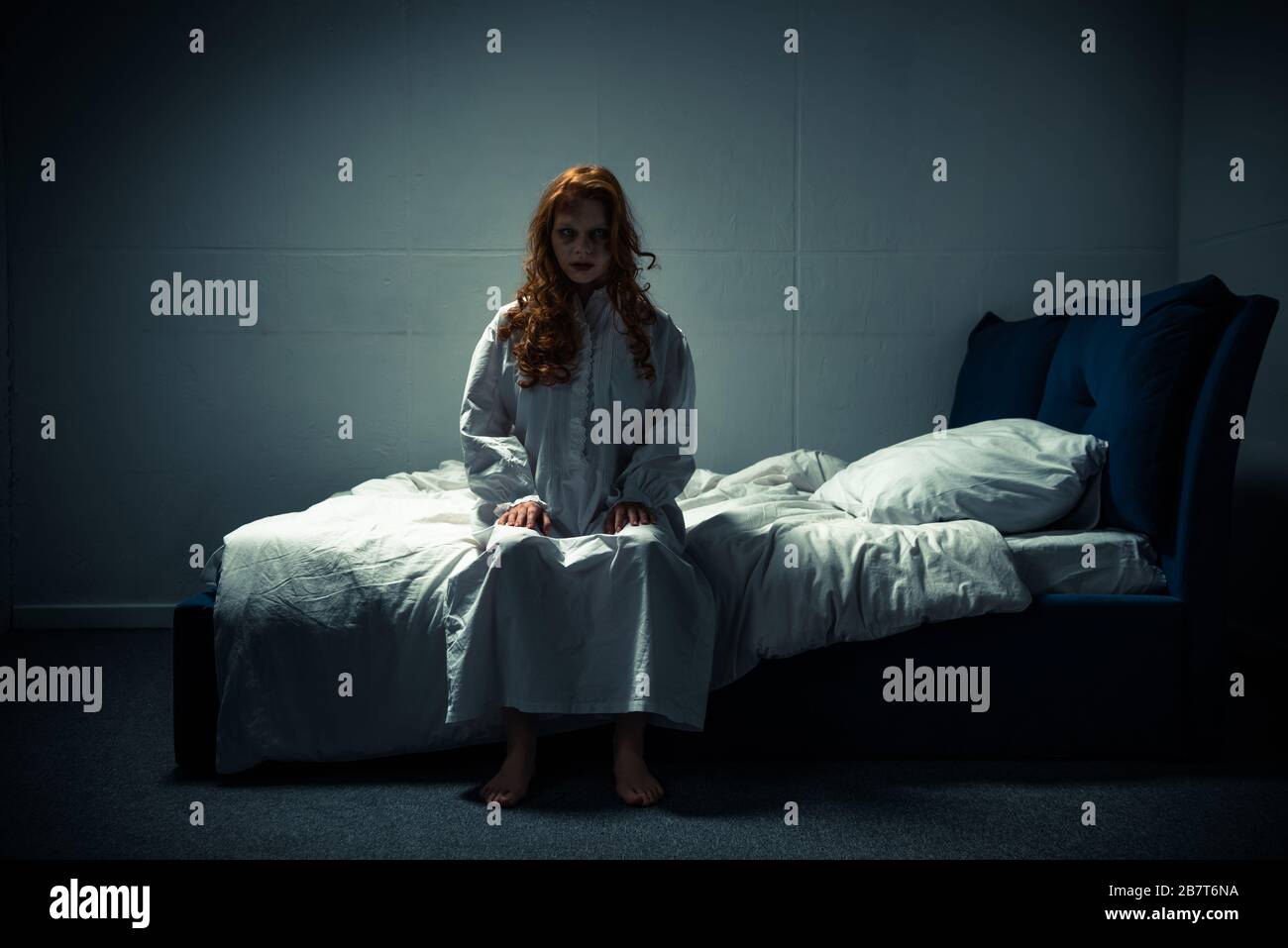 crazy obsessed woman in nightgown sitting on bed Stock Photo - Alamy