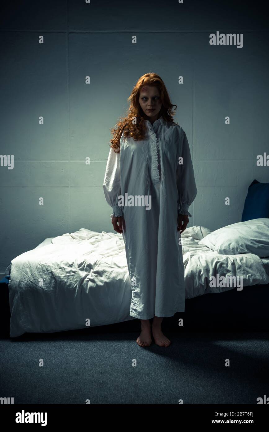 female demon in nightgown standing in bedroom Stock Photo - Alamy