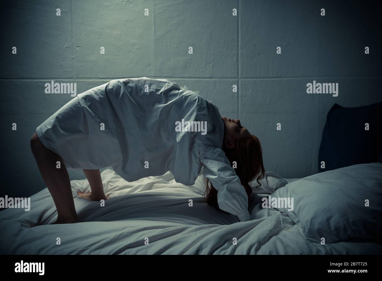 obsessed demonic girl in nightgown standing on legs and arms on bed ...