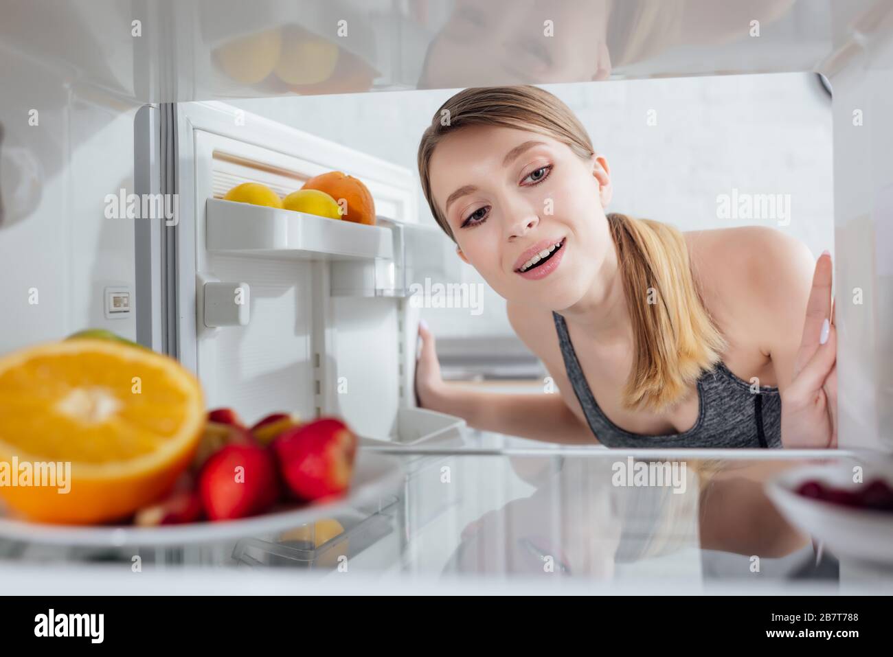Girl looking in fridge hi-res stock photography and images - Alamy