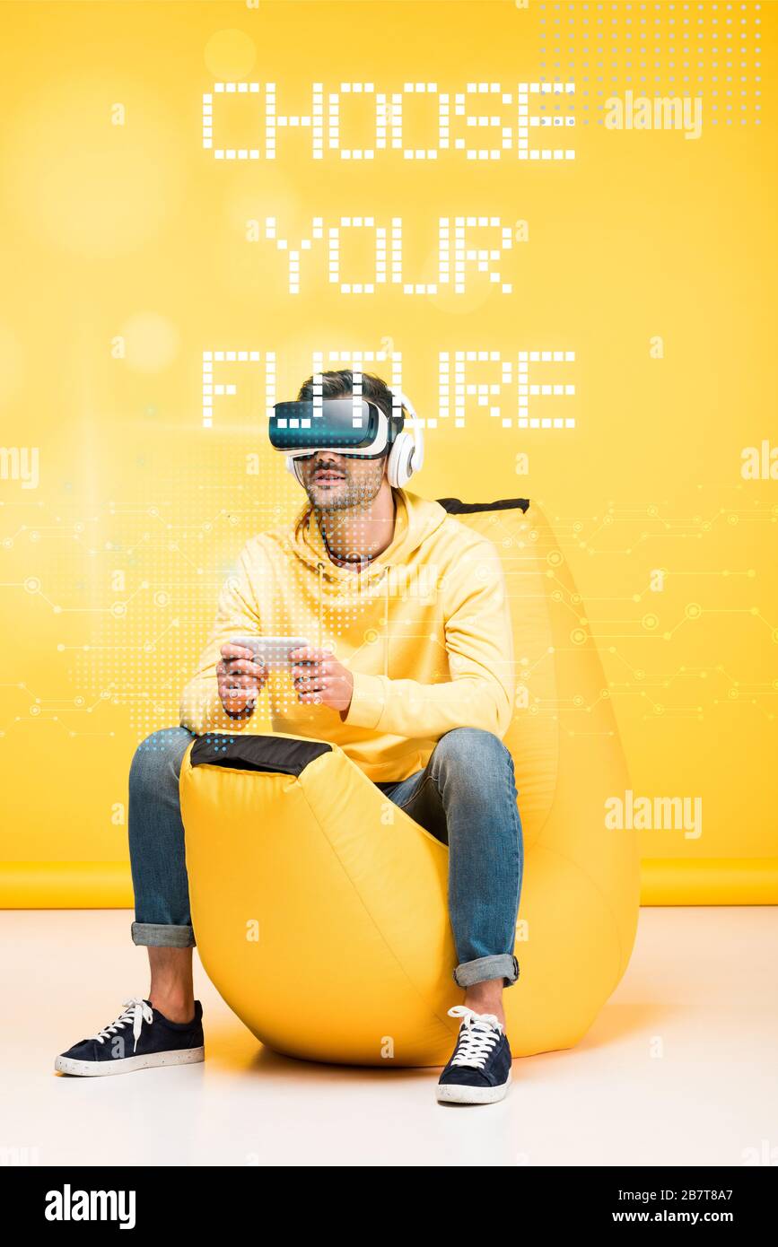 man on bean bag chair in virtual reality headset on yellow with choose ...