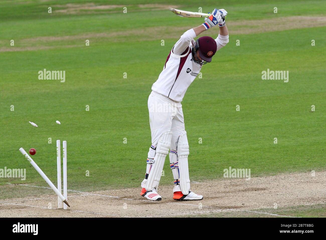 Alex Wakely of Northamptonshire CCC is bowled out by Jamie Porter Stock ...