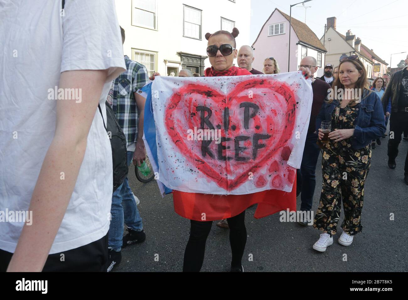 A fan with a RIP Keef flag follows the funeral procession of Prodigy ...